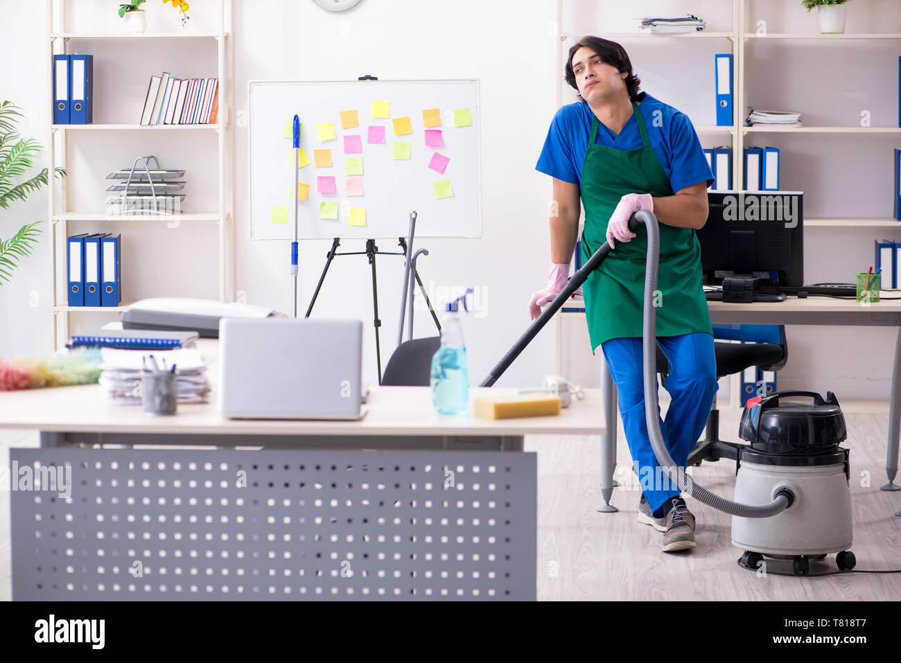 Male handsome professional cleaner working in the office Stock Photo ...