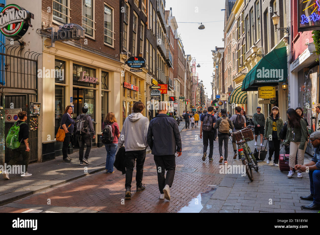 People at streets of Amsterdam during spring time Stock Photo - Alamy