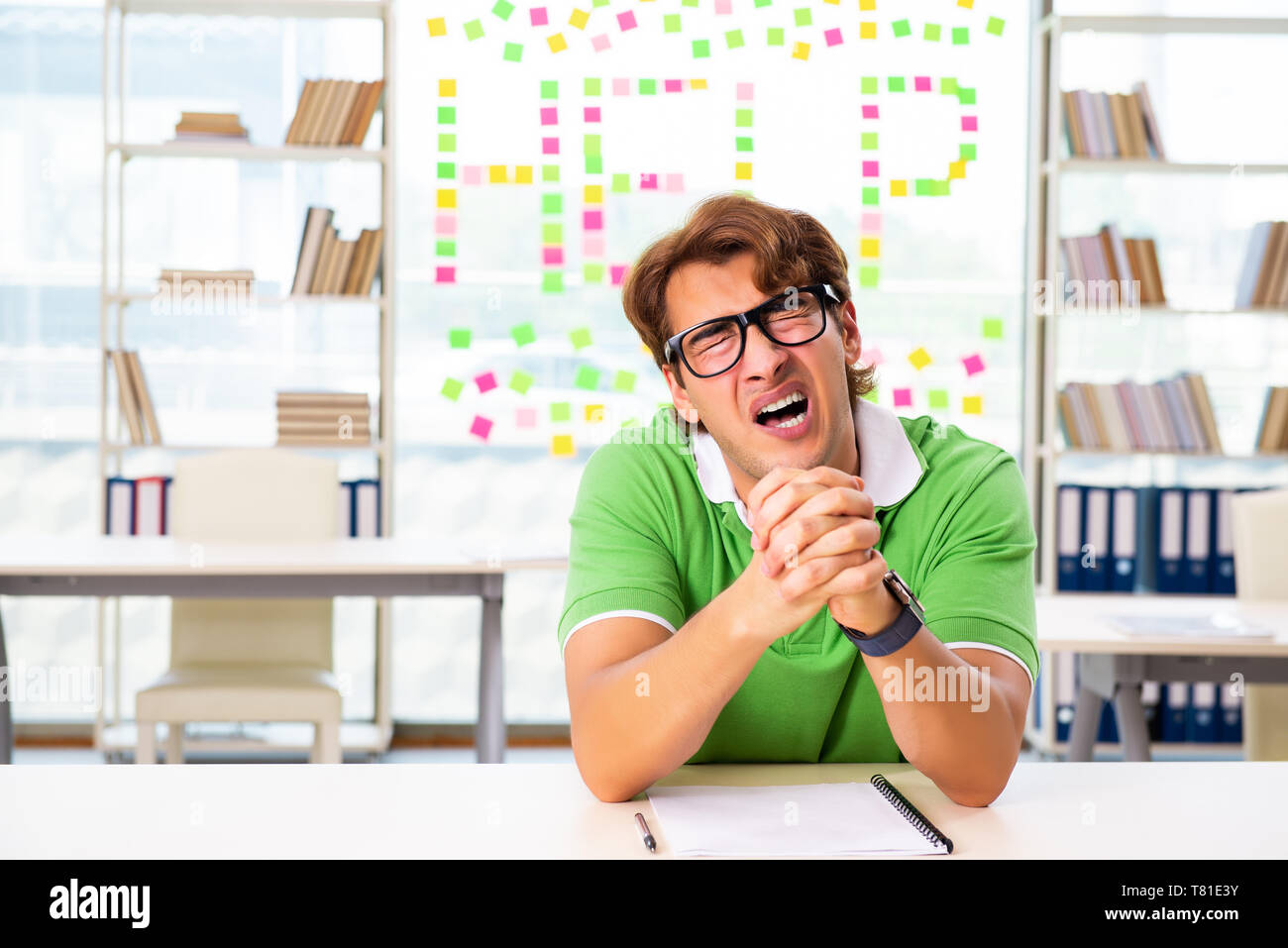 Student struggling at the exam in classroom Stock Photo - Alamy