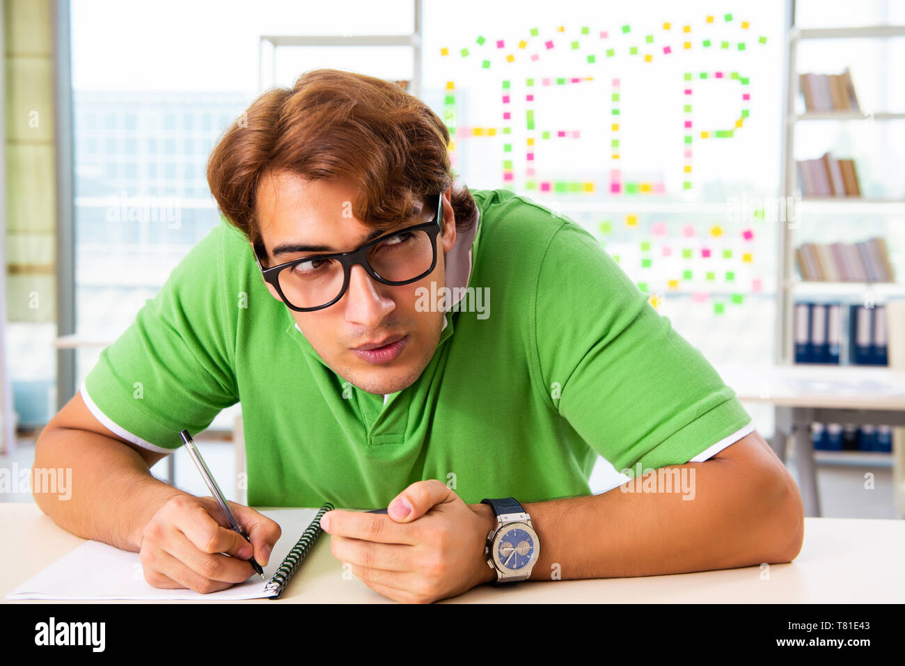Student struggling at the exam in classroom Stock Photo - Alamy