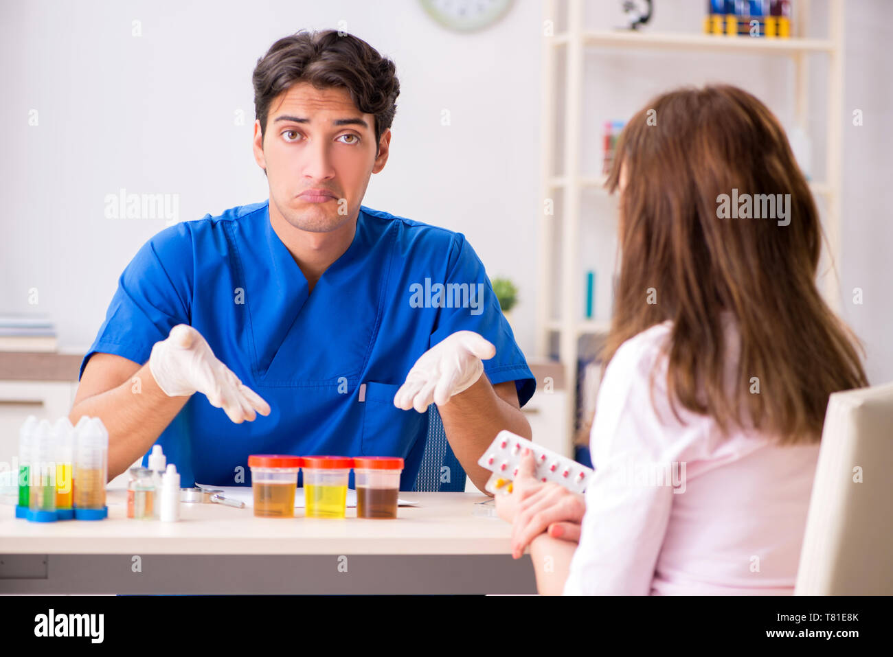 Patient visiting doctor for urine test Stock Photo - Alamy