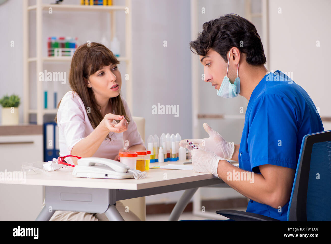 Patient visiting doctor for urine test Stock Photo - Alamy