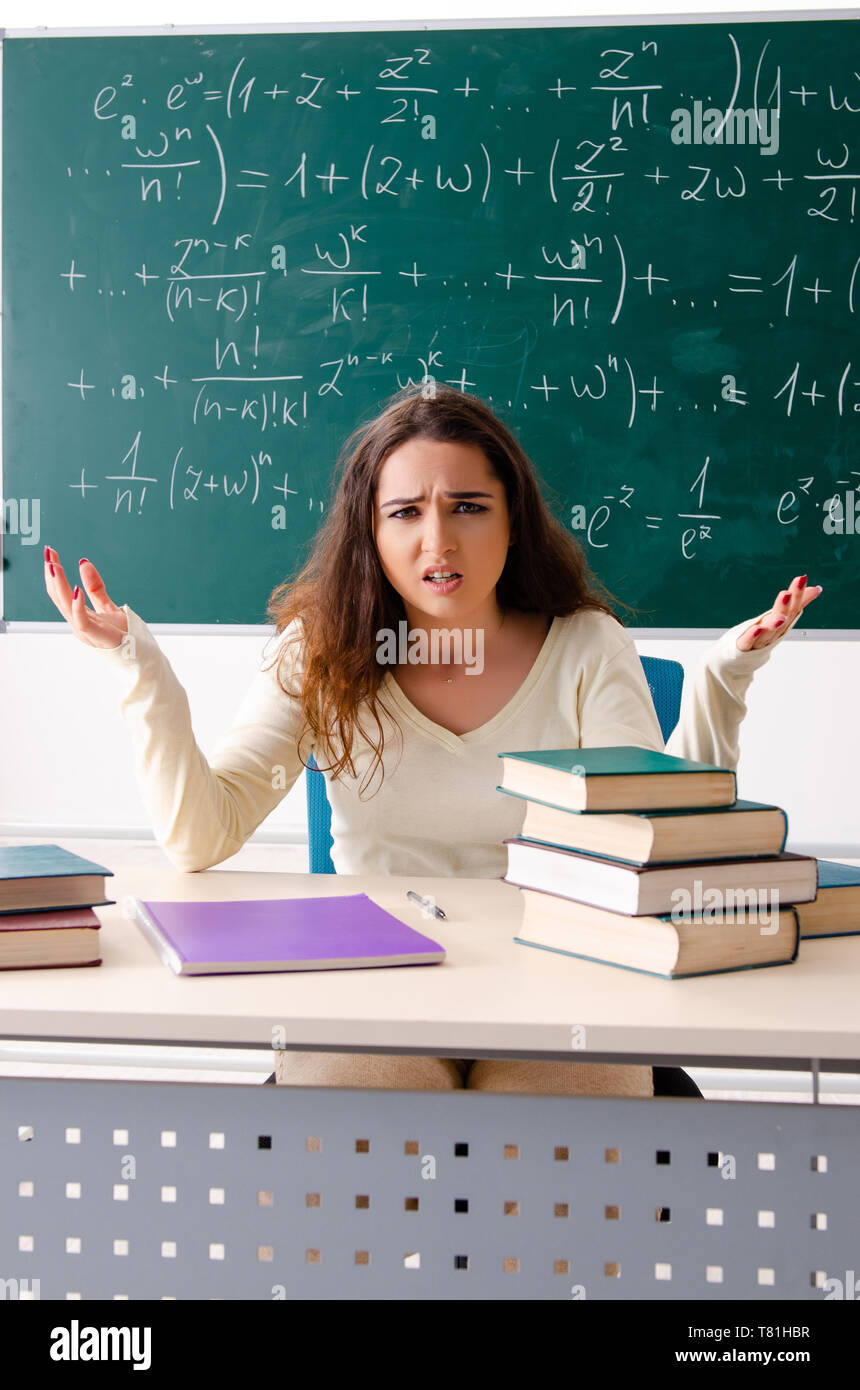 Young female math teacher in front of chalkboard Stock Photo - Alamy