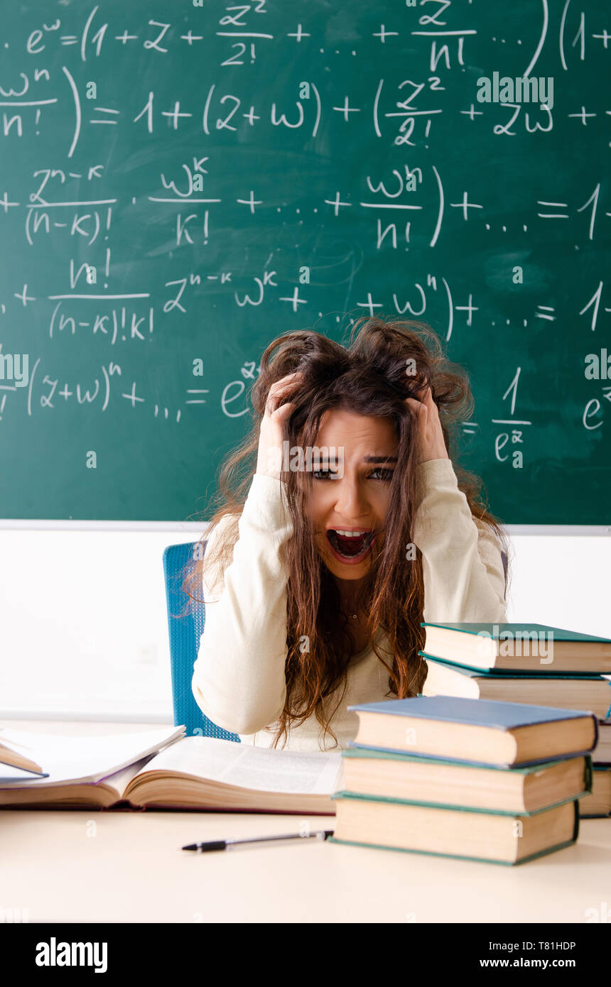 Young female math teacher in front of chalkboard Stock Photo - Alamy