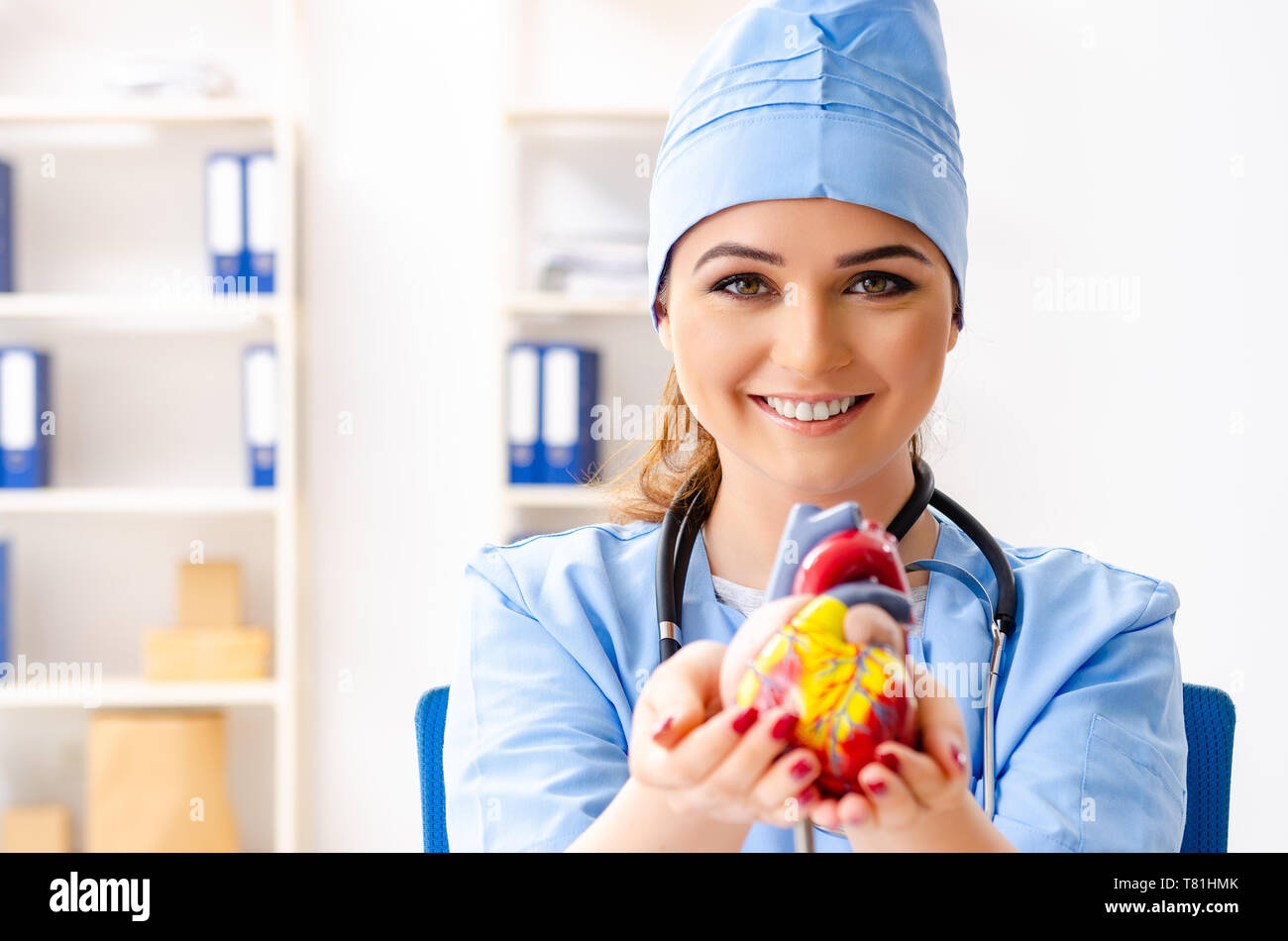 Young female doctor cardiologist sitting at the hospital Stock Photo ...