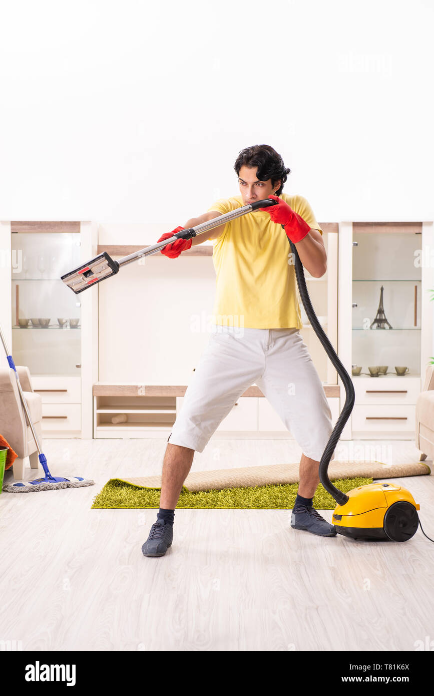 Young handsome man doing housework Stock Photo - Alamy