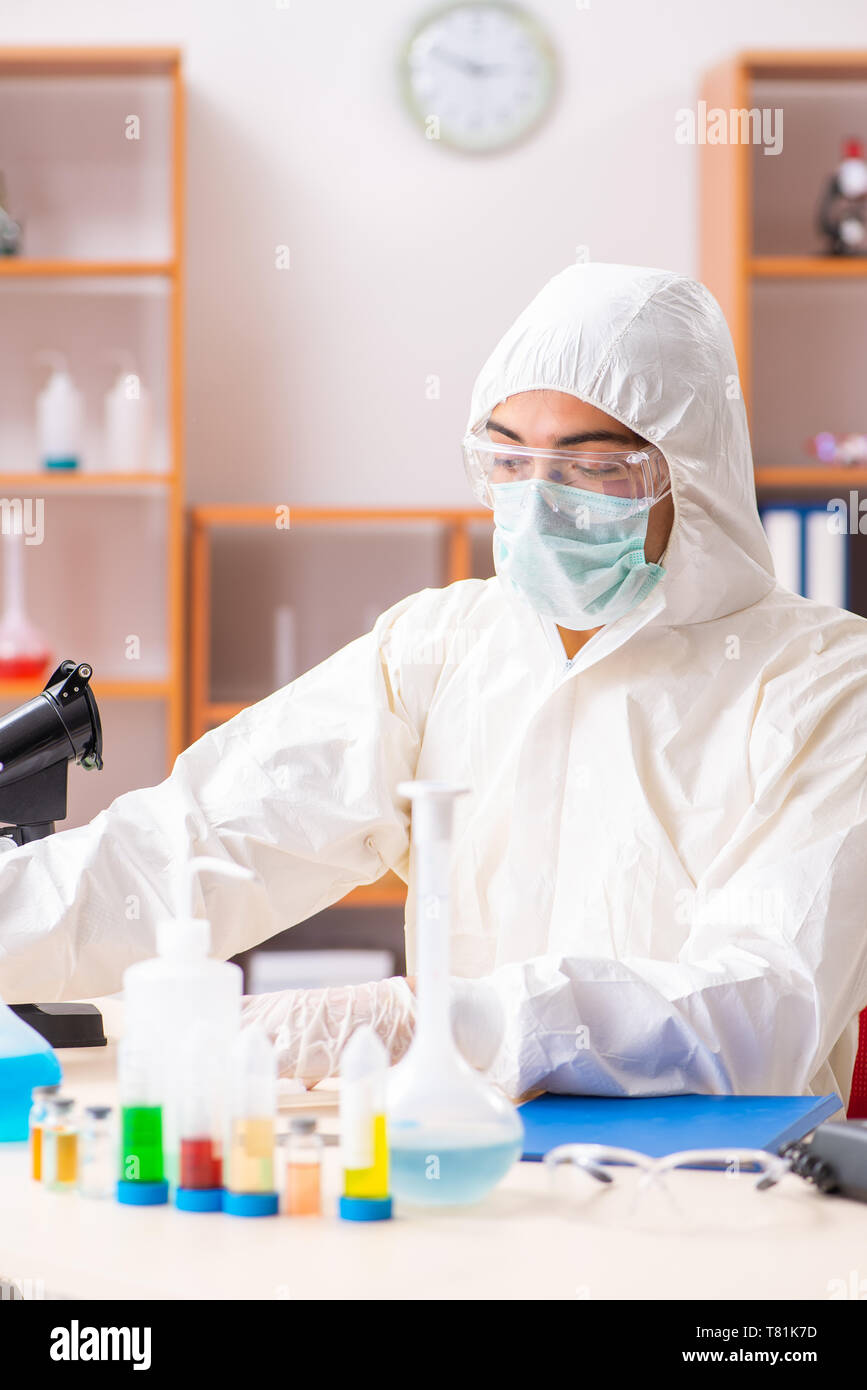 Young biochemist wearing protective suit working in the lab Stock Photo ...