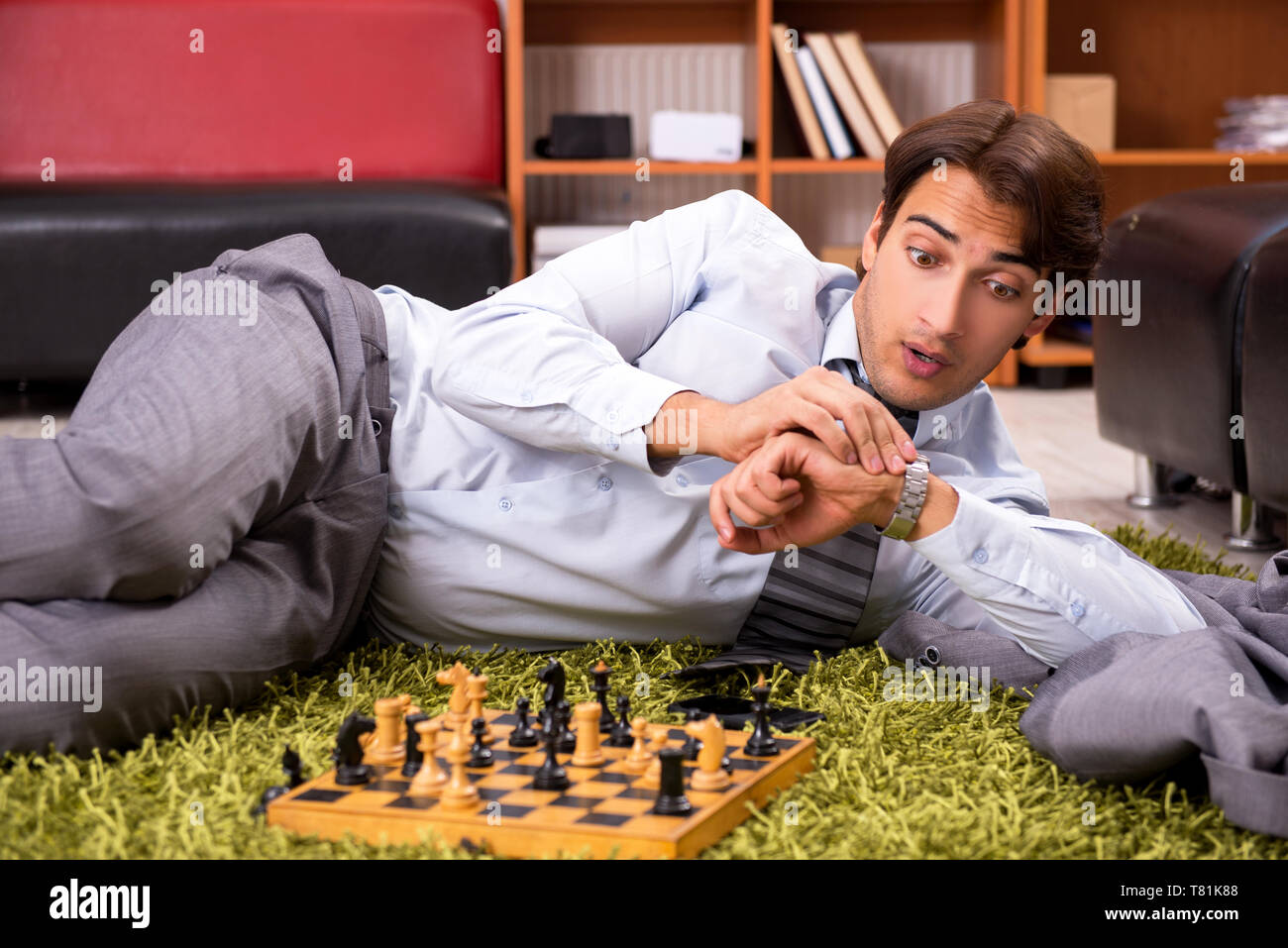Young handsome boss playing chess during break Stock Photo - Alamy