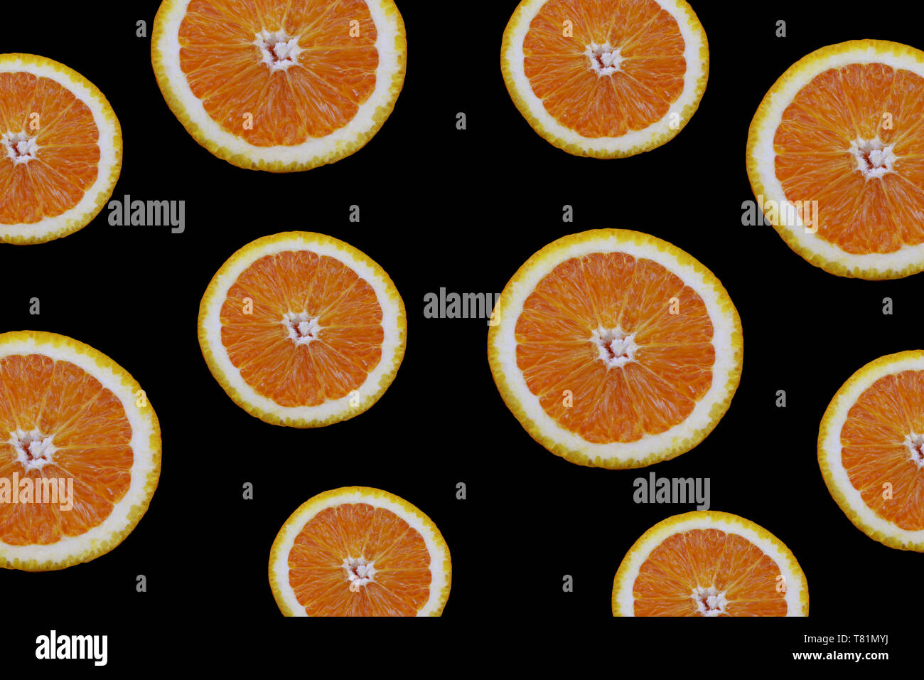 many half a ripe orange slice on black background Stock Photo - Alamy