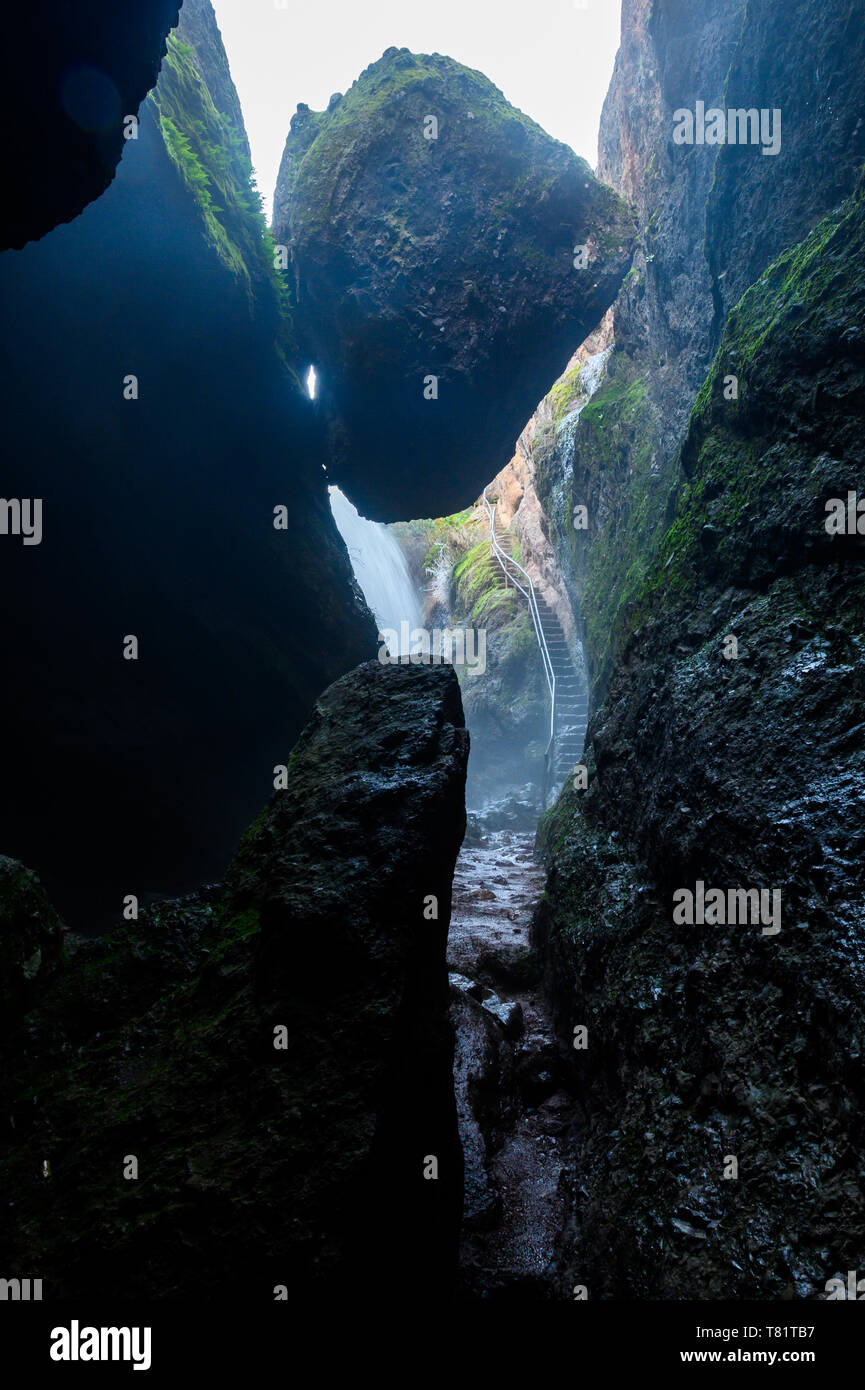 Rock Wedged Above Water Fall through narrow passageway Stock Photo - Alamy