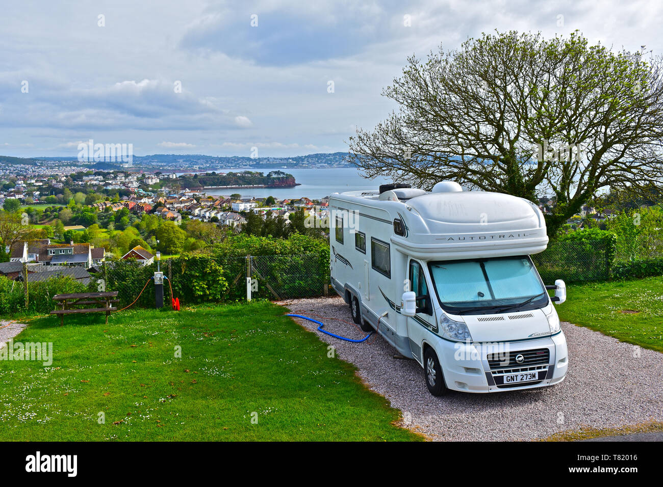A modern motorhome on a fully serviced hard-standing pitch with ...