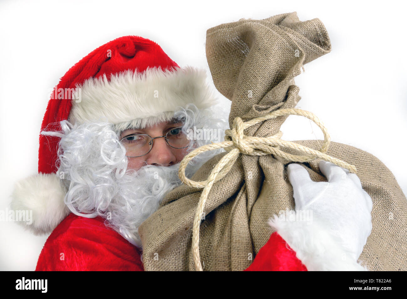 Closeup of Santa Claus with big sack full of christmas presents over ...
