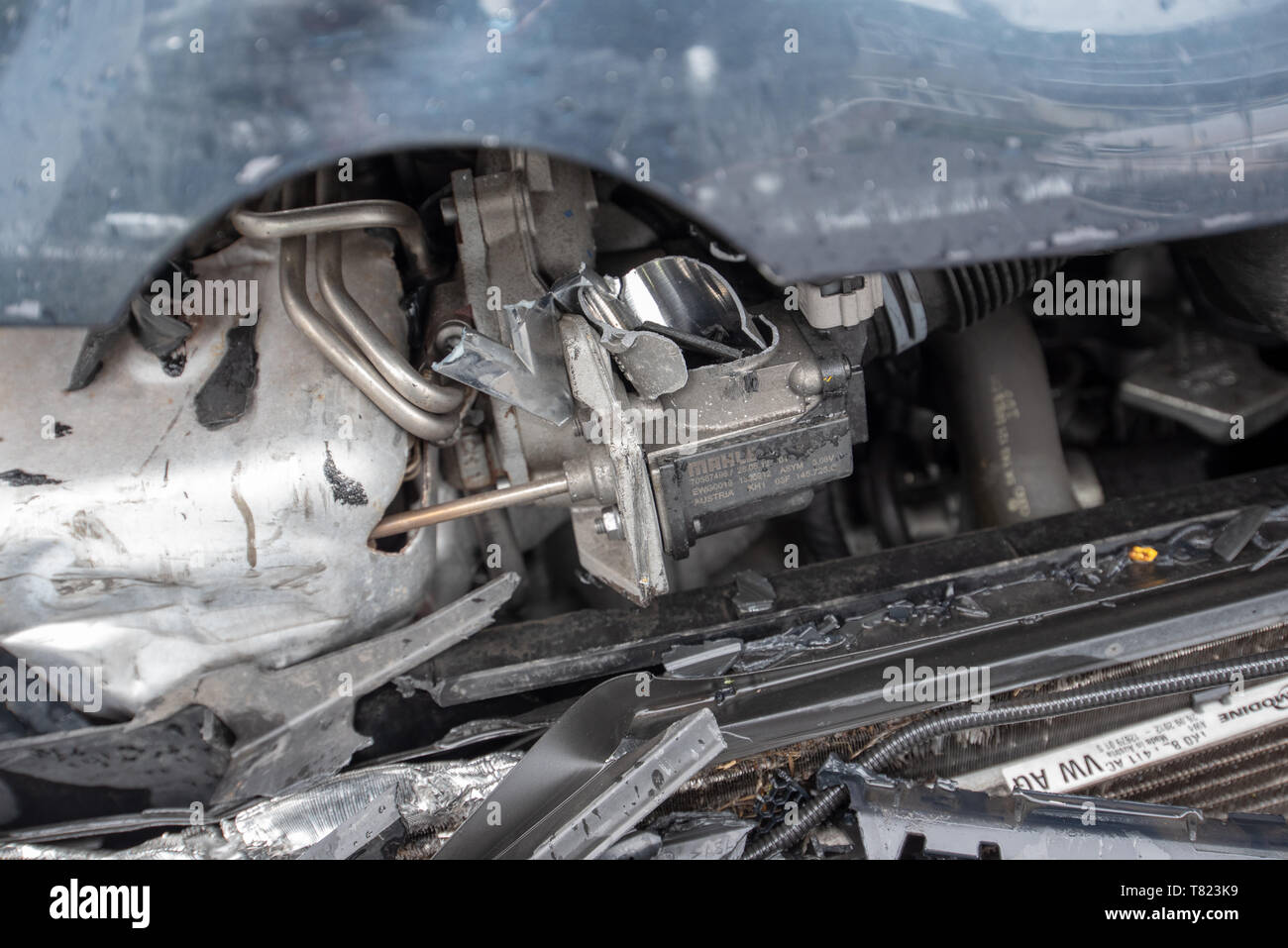 Volkswagen Badge, smashed badge and engine components. Car crash ...