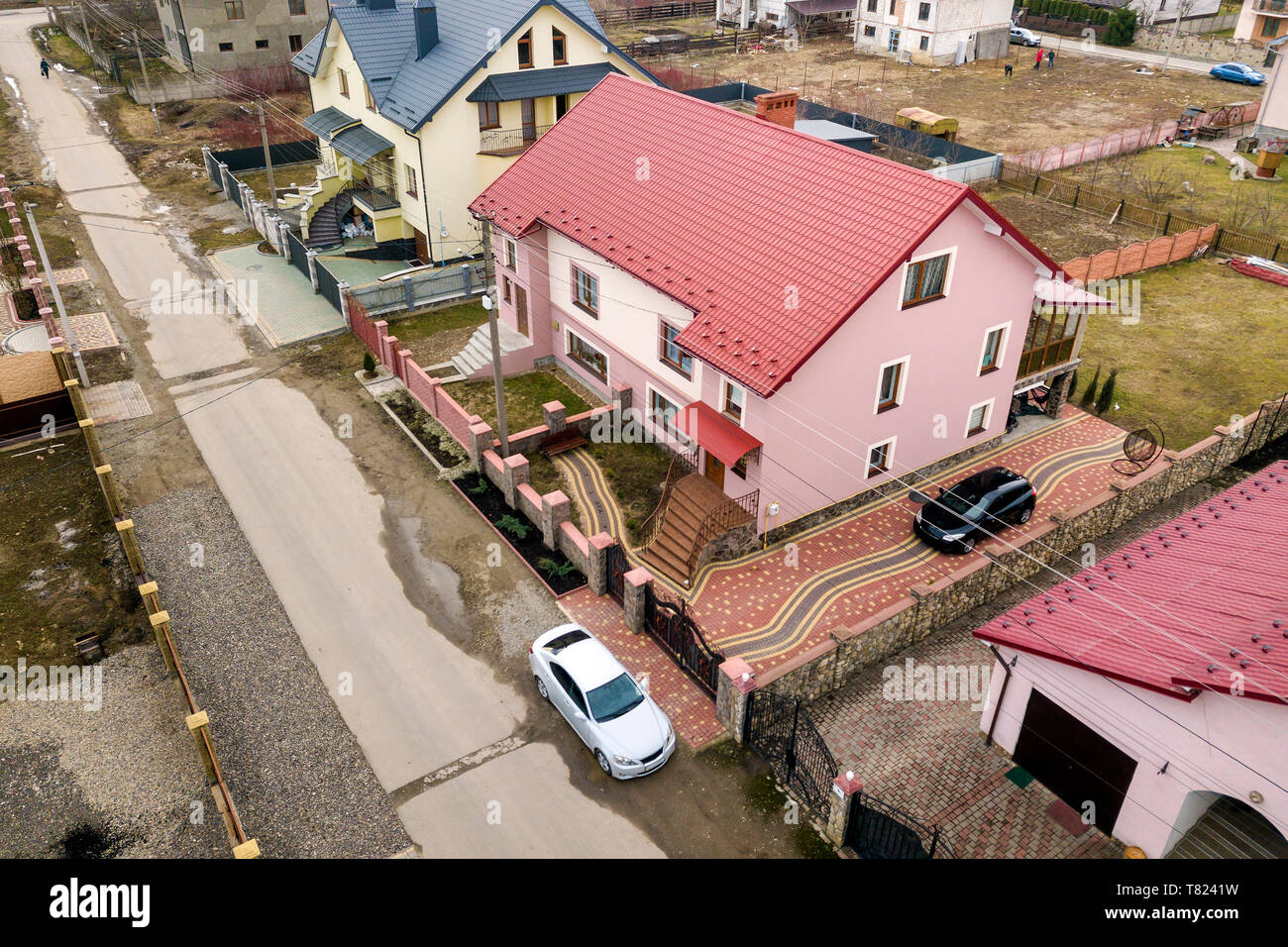 Aerial top view of suburb area with nice houses and cars on sunny day ...