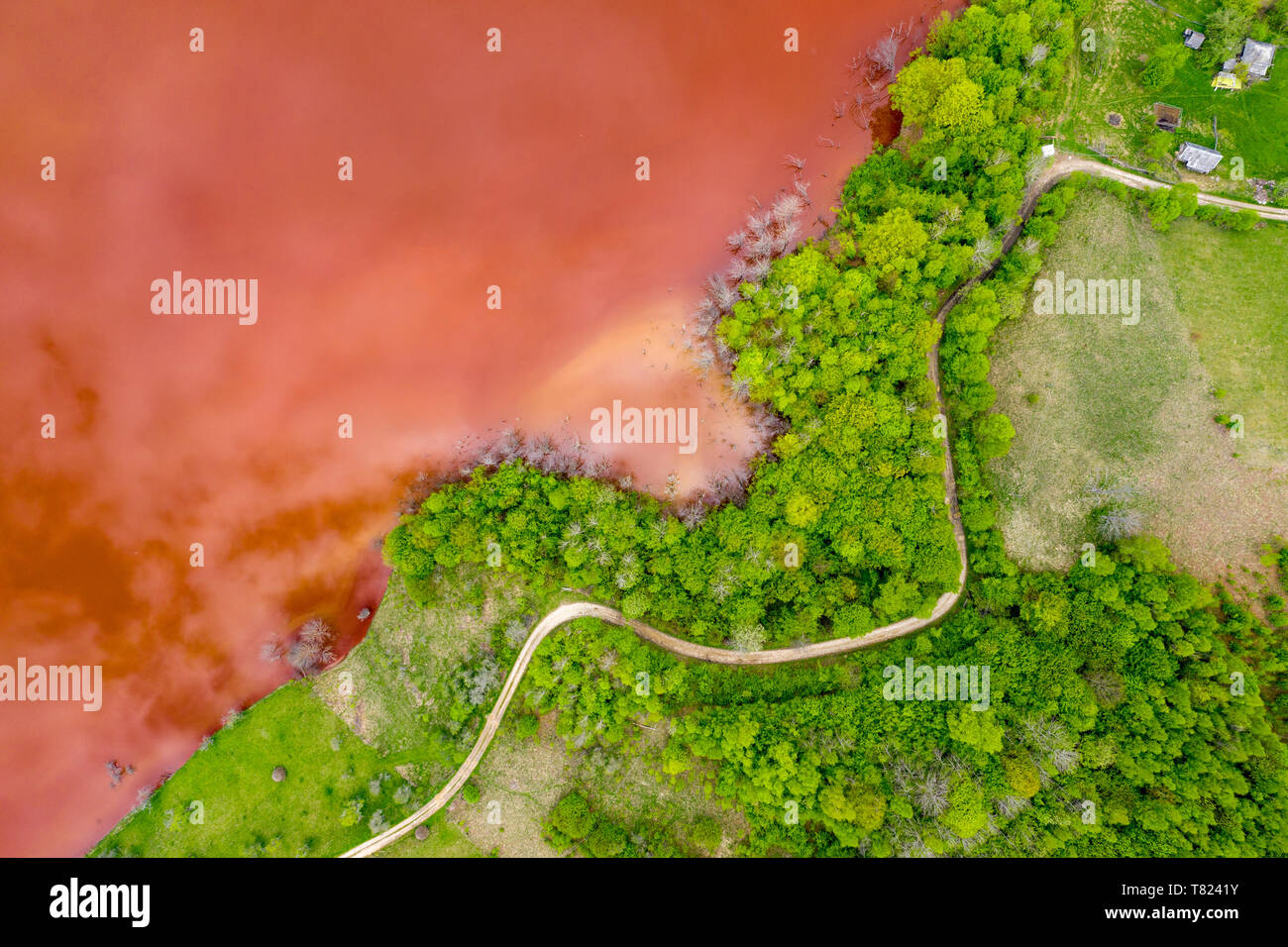 Aerial view of colorful red copper mining waste water in contrast with ...