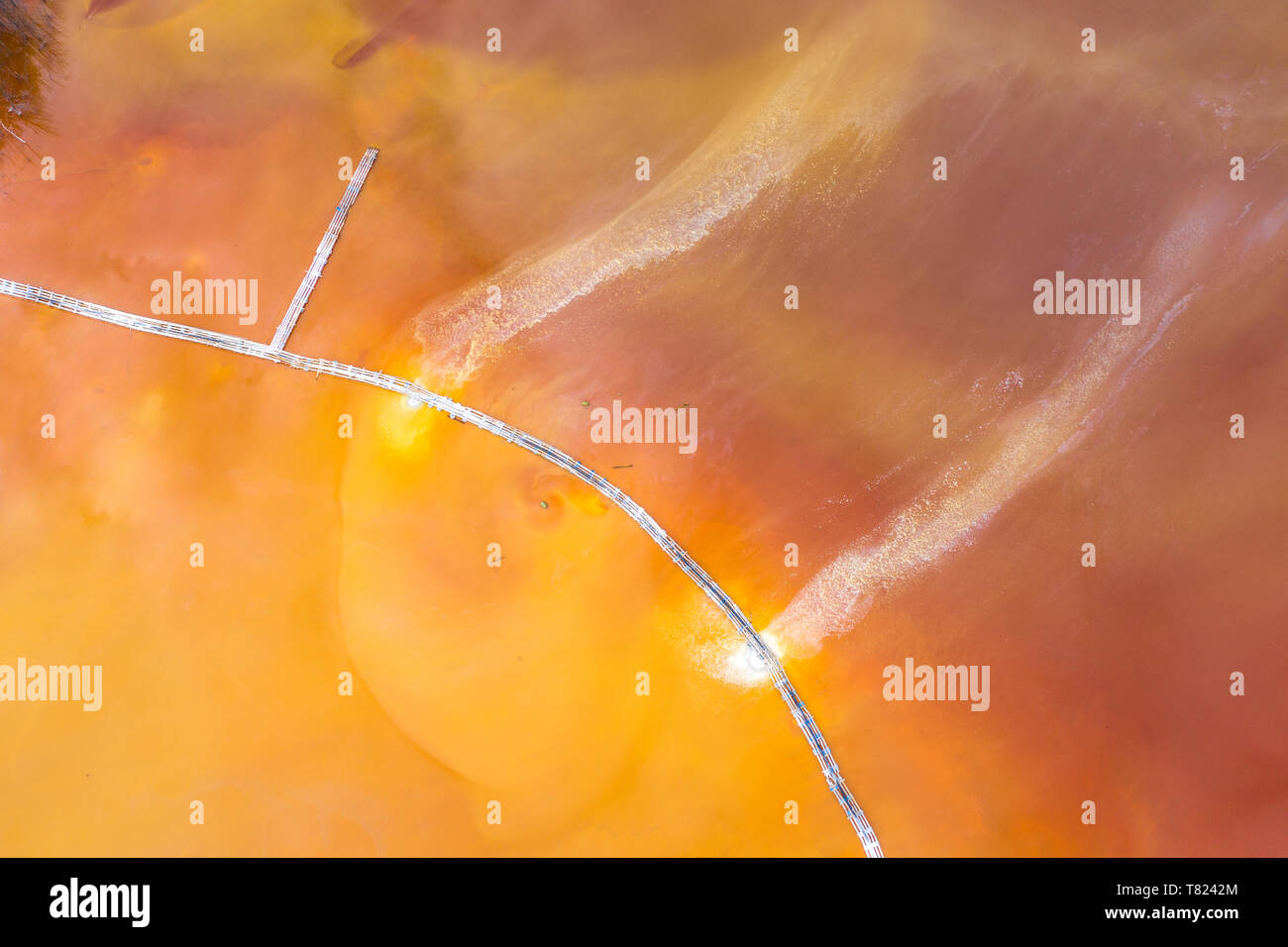 Aerial view of chemical mining waste residuals flooding into a settling ...
