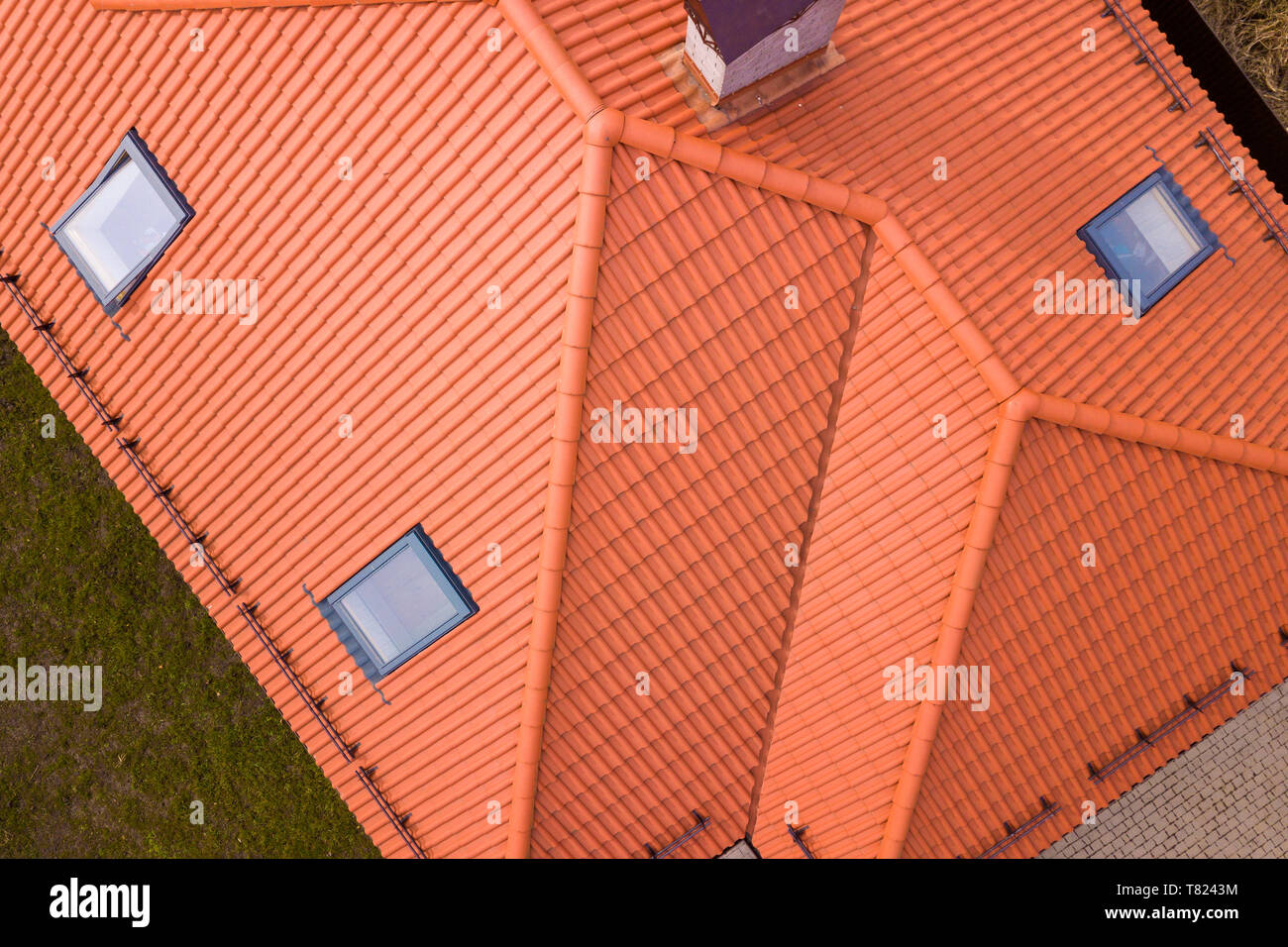 Aerial top view of house metal shingle roof, brick chimneys and small ...