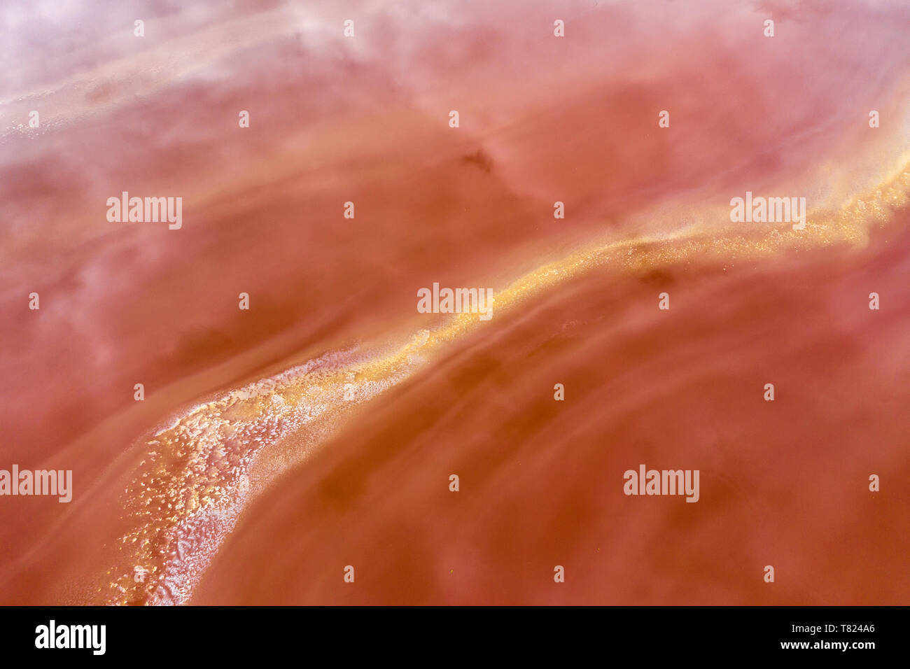 Abstract aerial background of red mining water from copper expoitation ...