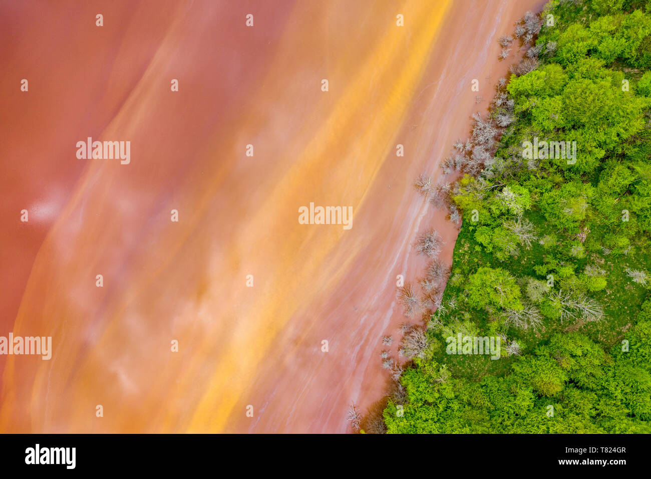 Aerial view of colorful red copper mining waste water in contrast with ...