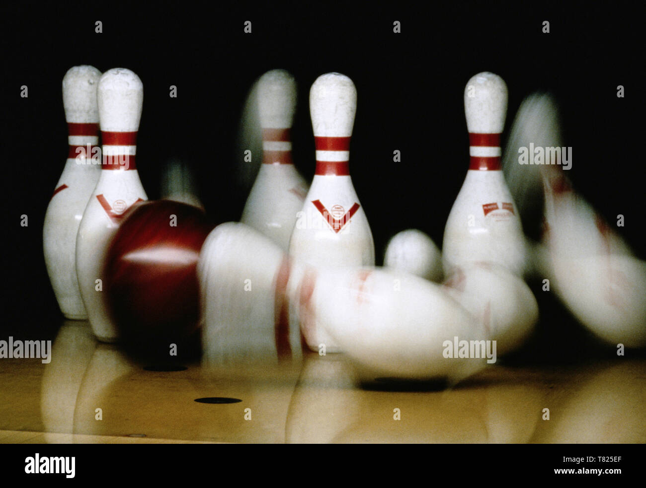Action image of a bowling ball striking pins in a bowling alley, USA ...