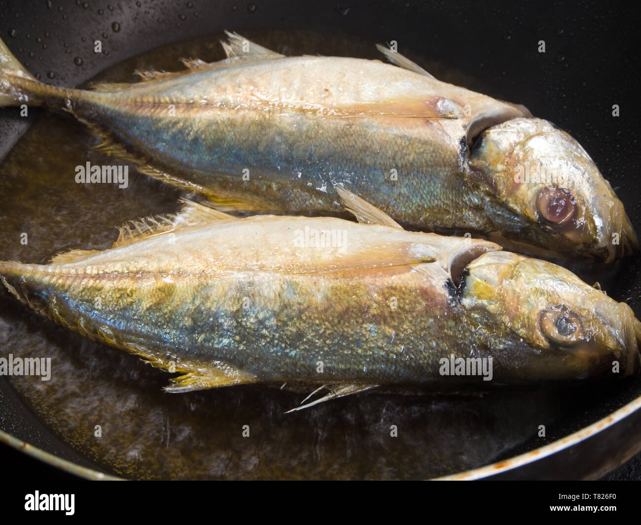 Twin Sea fish frying in a Pan Stock Photo - Alamy