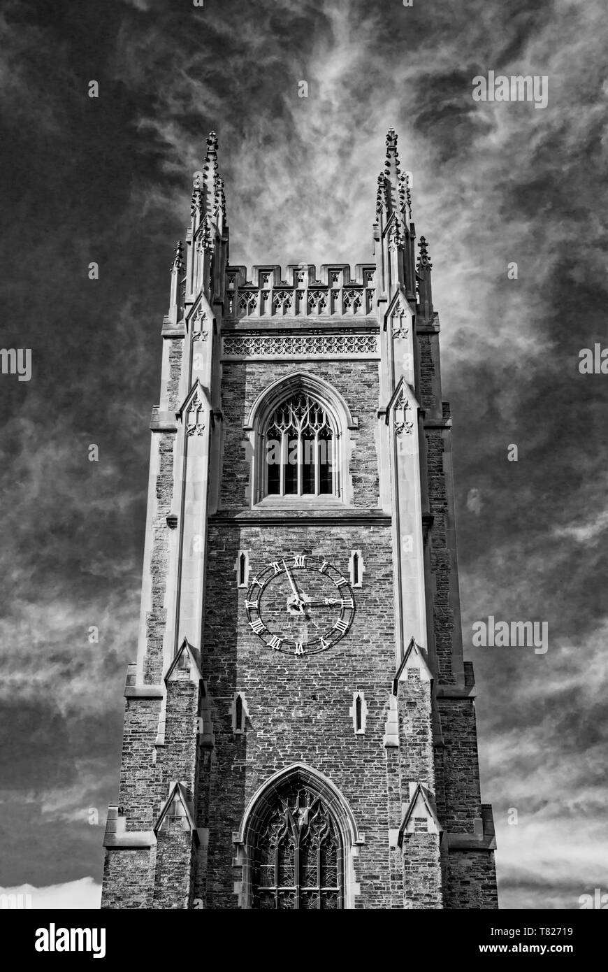 Gothic tower in front of bright blue sky with white cirrus clouds Stock ...