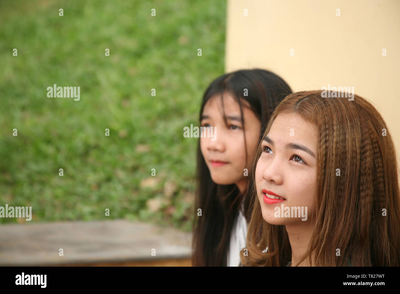 photo of two girls looking over to the left Stock Photo - Alamy