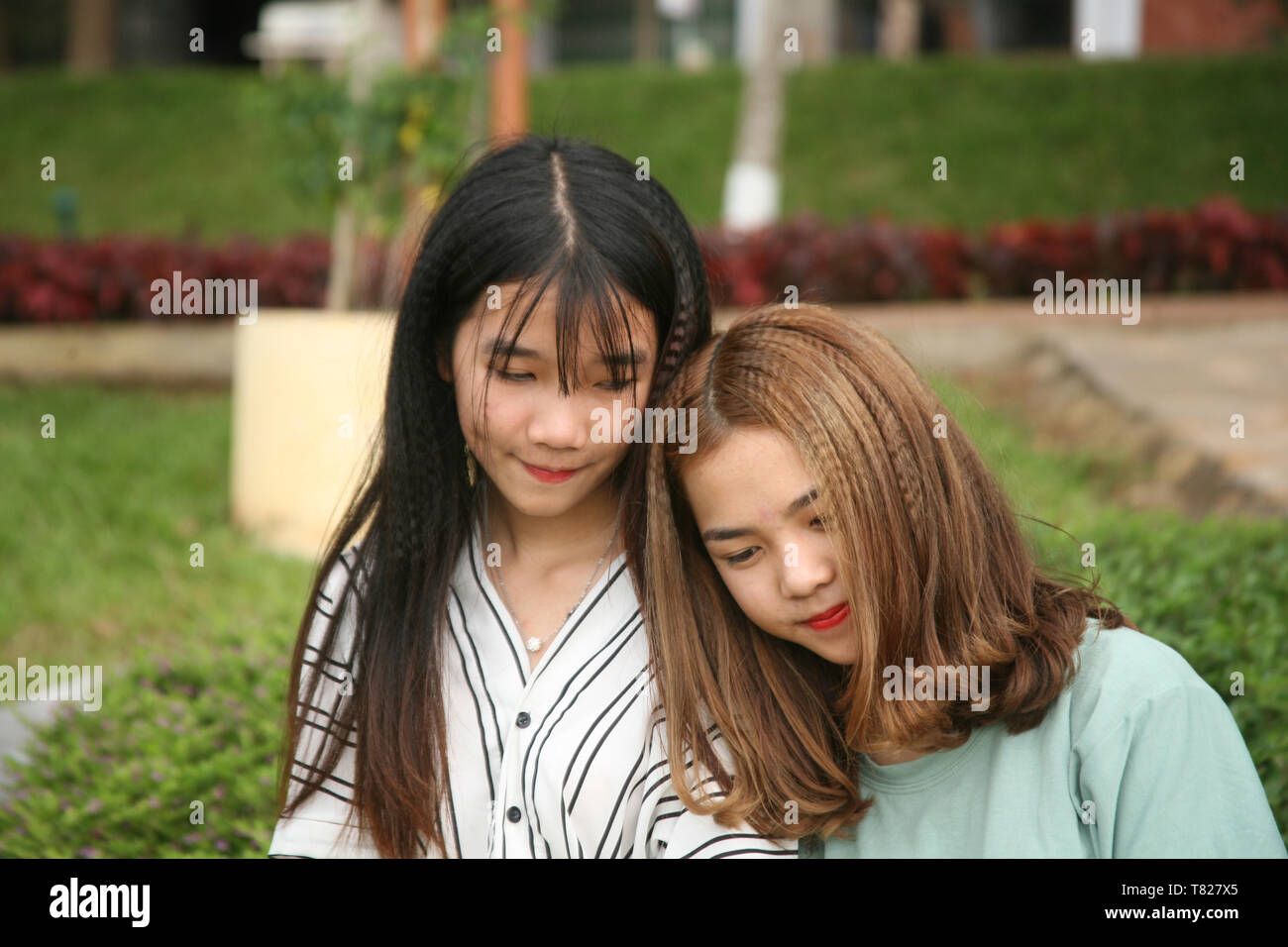 photo of a girl leaning on another girl Stock Photo - Alamy
