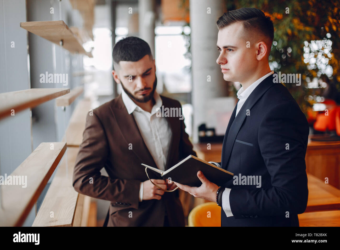 Two handsome men working. Friends in a cafe. Man in a suit with ...