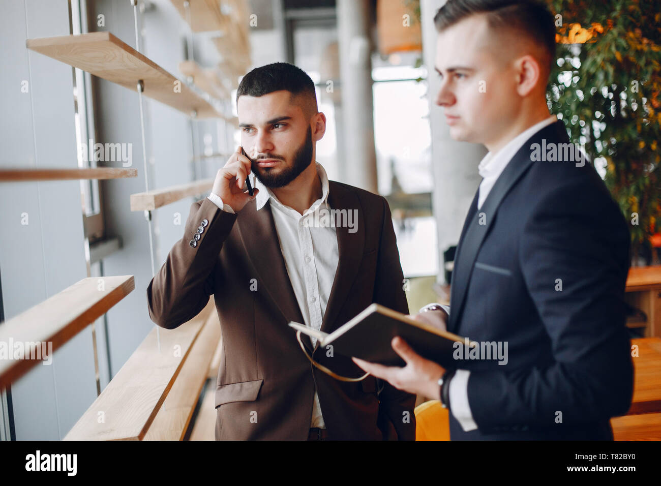 Two handsome men working. Friends in a cafe. Man in a suit with ...