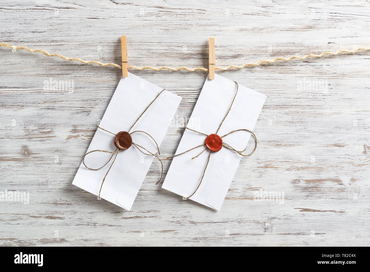 White envelopes hanging on rope Stock Photo - Alamy