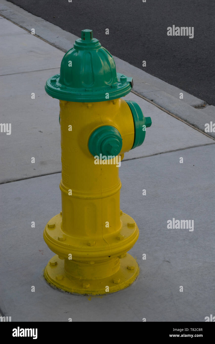 Yellow and Green Painted fire hydrant Stock Photo - Alamy