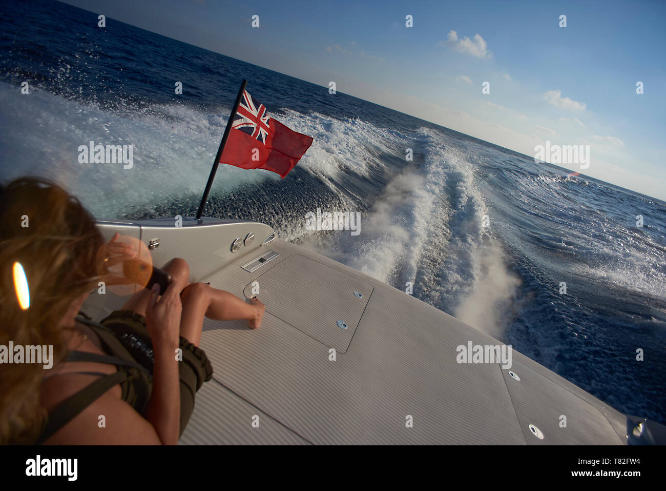 Close up of the side of a modern luxury speed boat having fun racing in ...