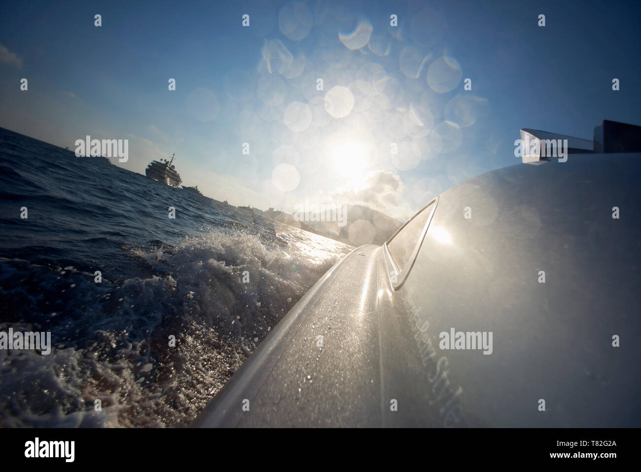 Close up of the side of a modern luxury speed boat having fun racing in ...