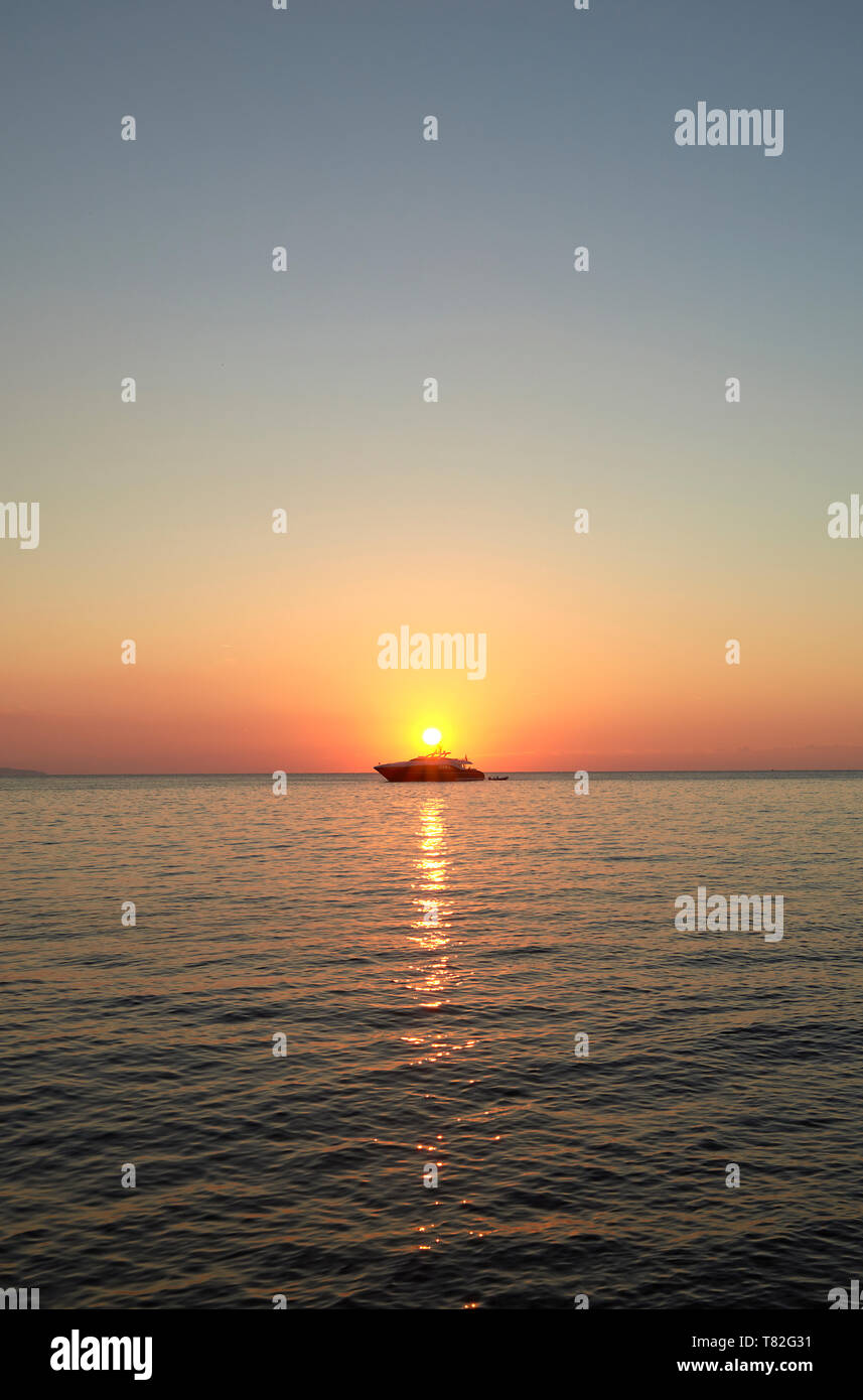 Amazing image of an ankered yacht in the middle of the sun during ...