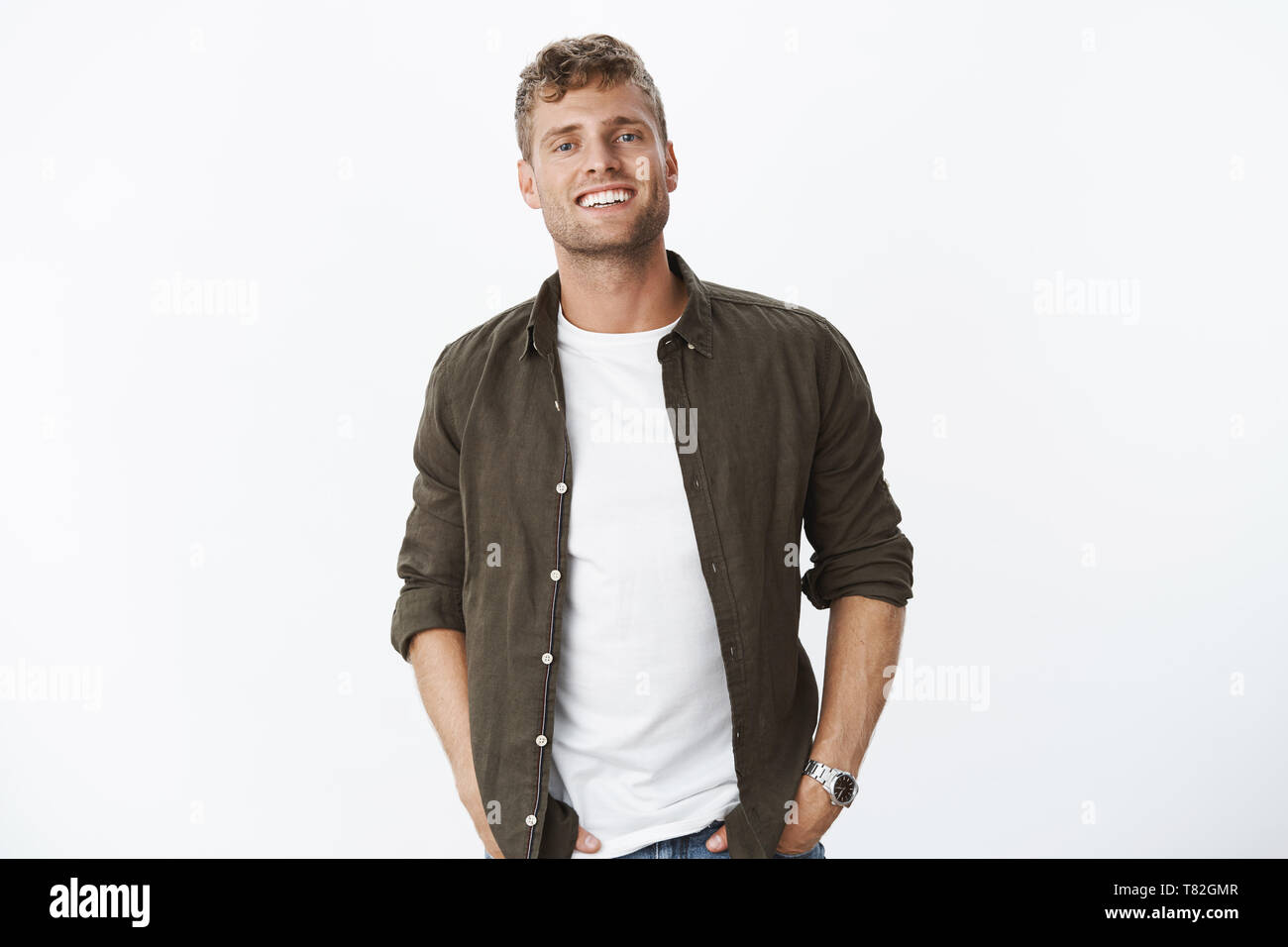 Relaxed, friendly good-looking european guy with bristle smiling ...