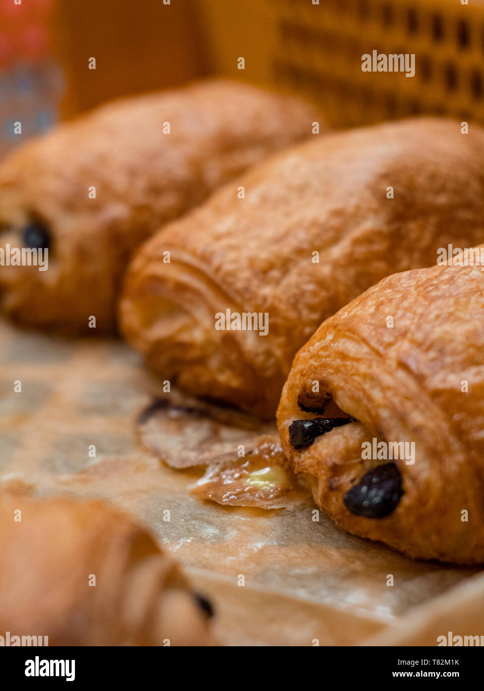 Chocolate croissants rows on a shelf in a bakery shop Stock Photo - Alamy