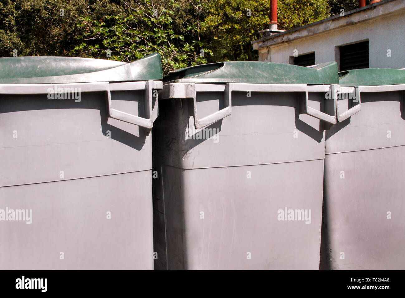 Large garbage containers, trash dumpsters and bins standing in row ...