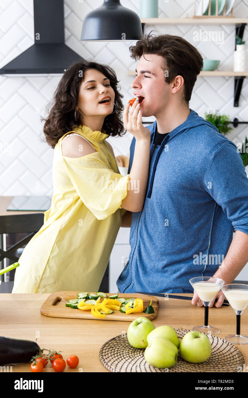 Young cute smiling couple cooking together at kitchen at home. Cute ...