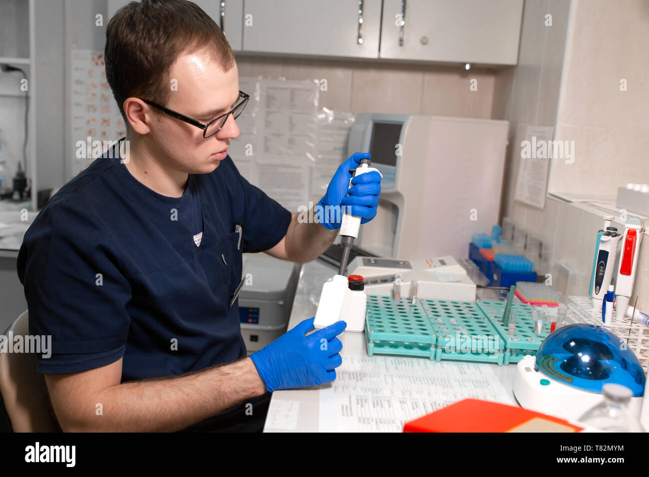 laboratory assistant analyzing a blood sample using micropipette Stock ...