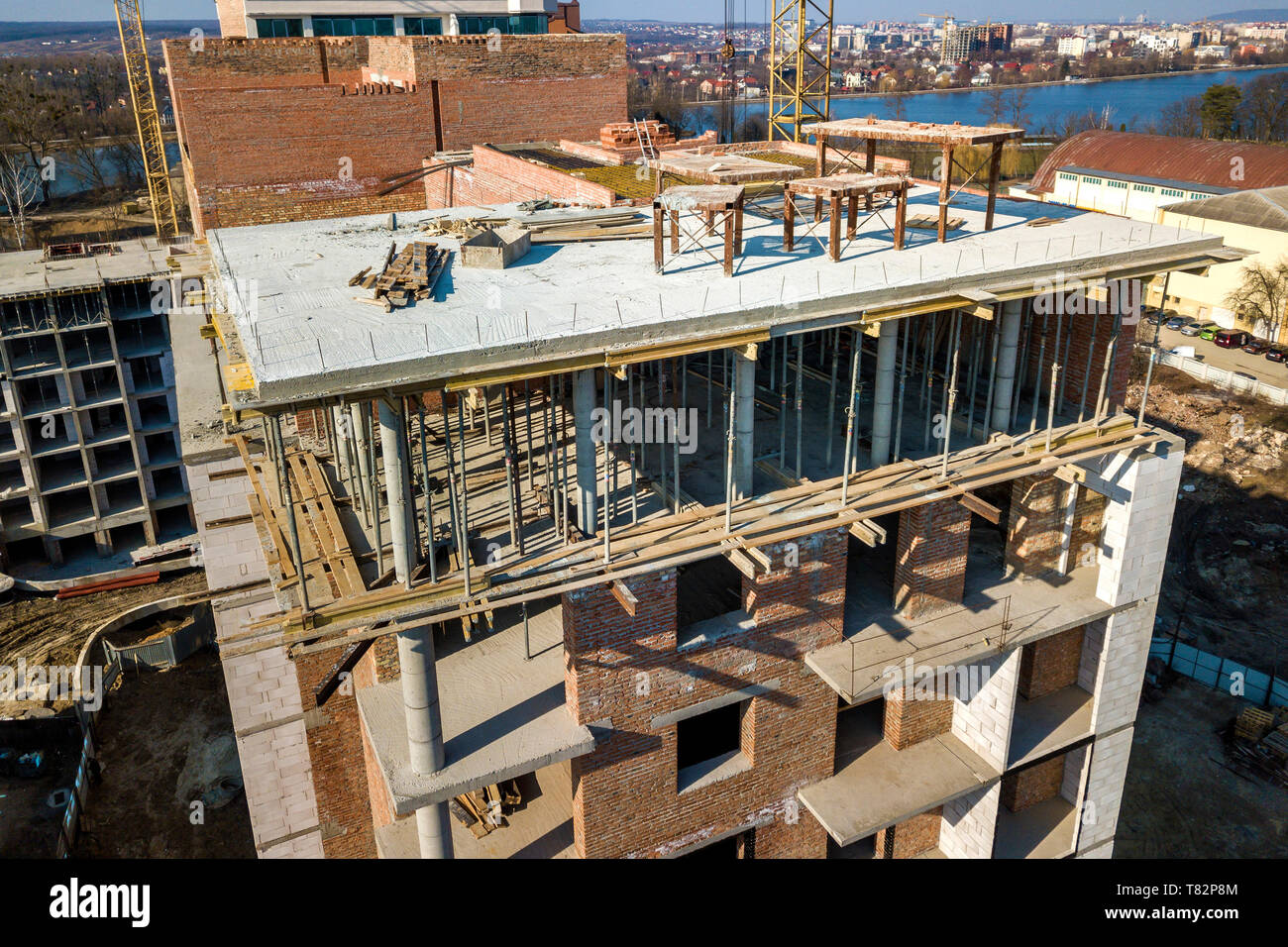 Apartment or office tall building under construction, top view. Brick ...
