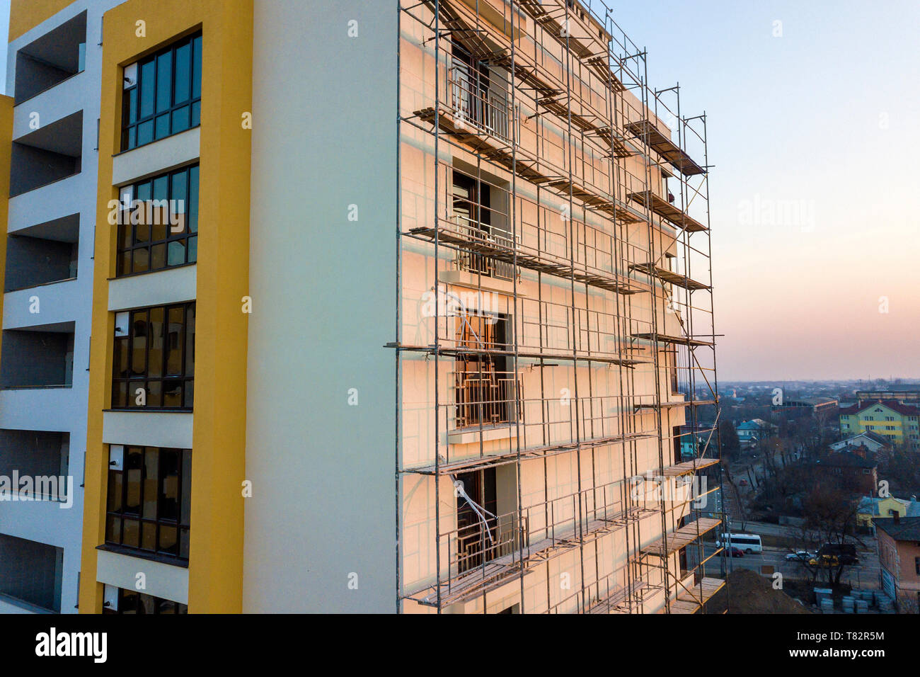 Apartment or office tall unfinished building under construction. Brick ...