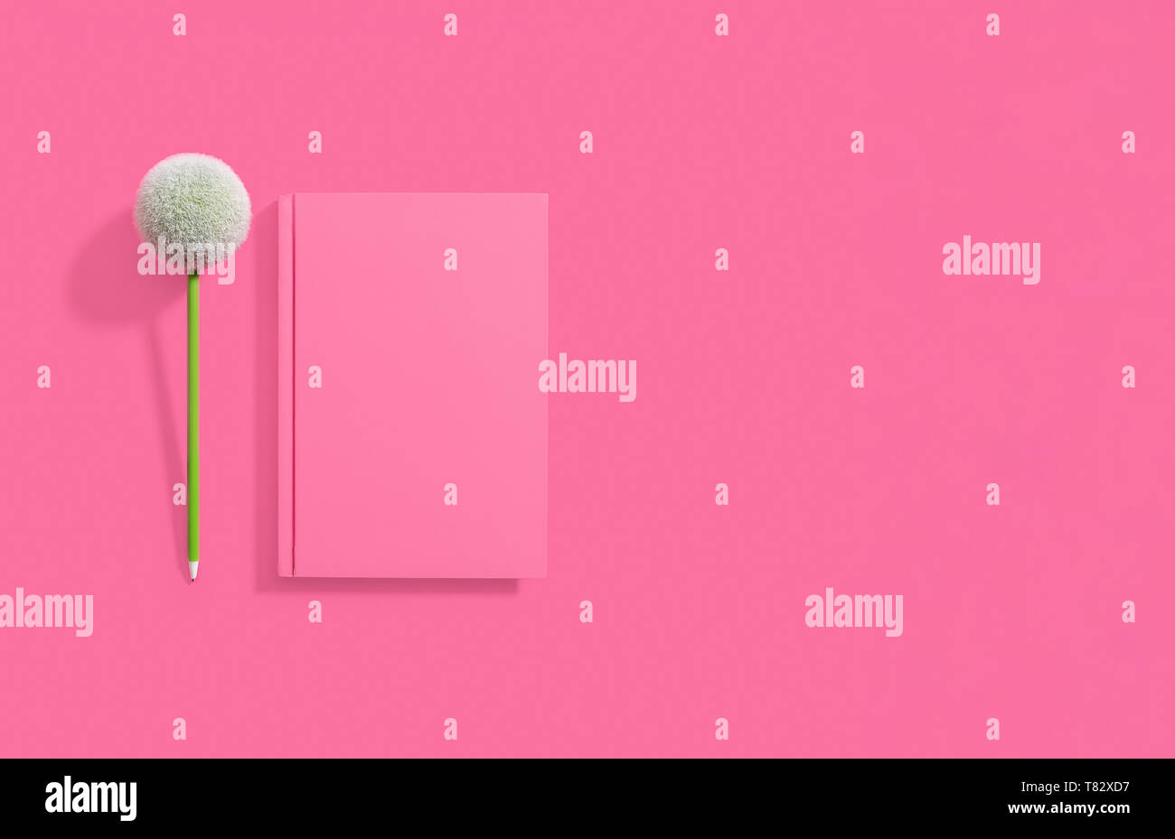 Pink notebook, diary, journal on a matching pink background with green ...