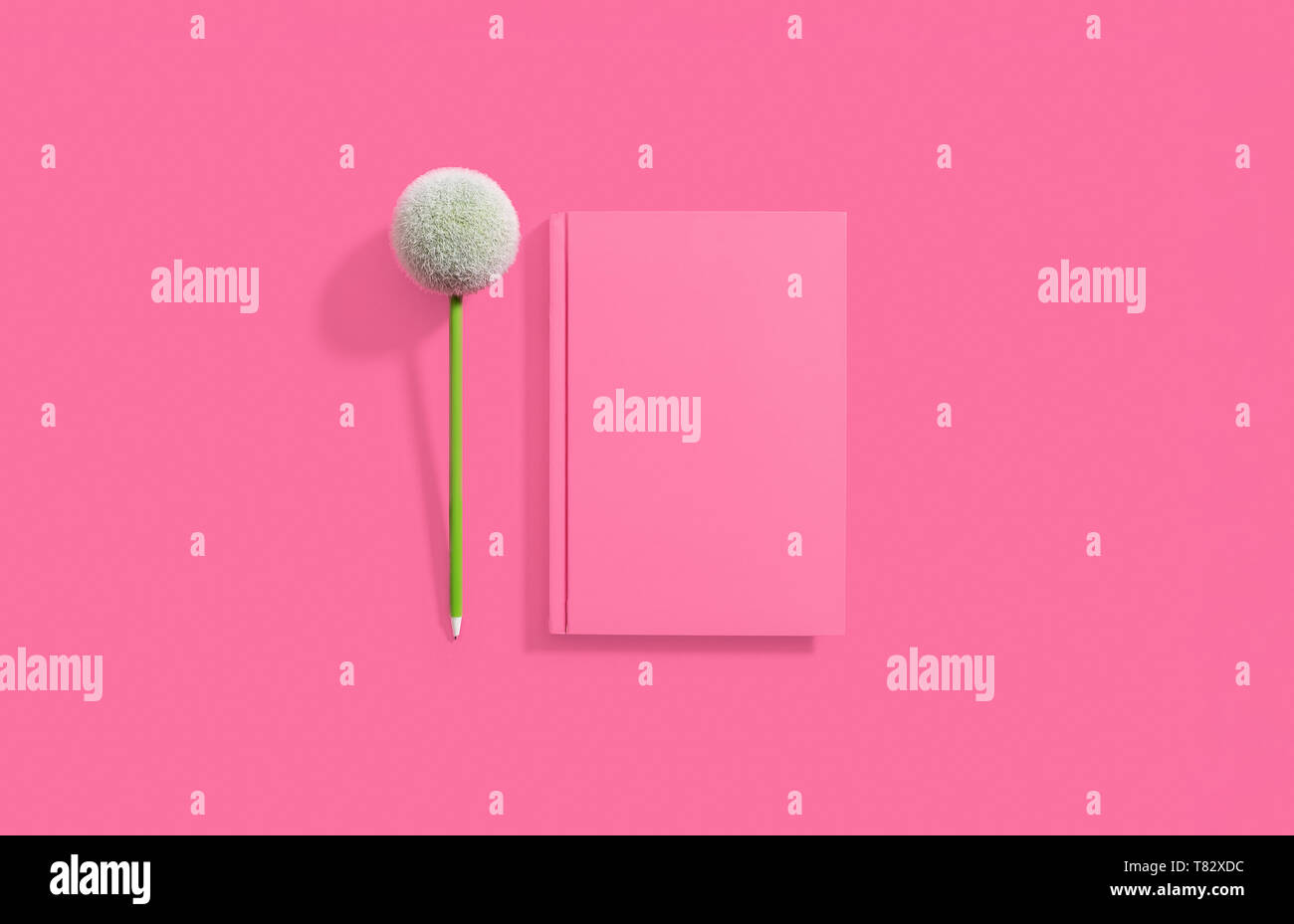 Pink notebook, diary, journal on a matching pink background with green ...
