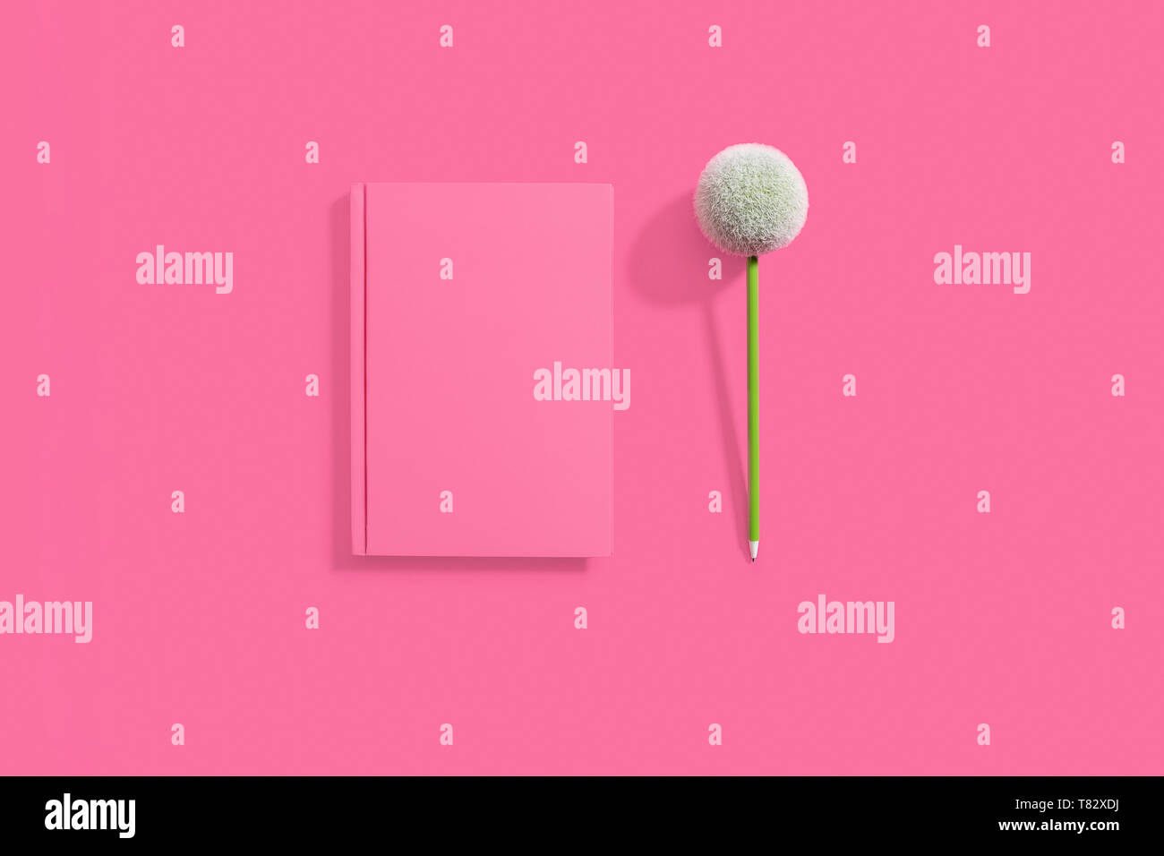 Pink notebook, diary, journal on a matching pink background with green ...