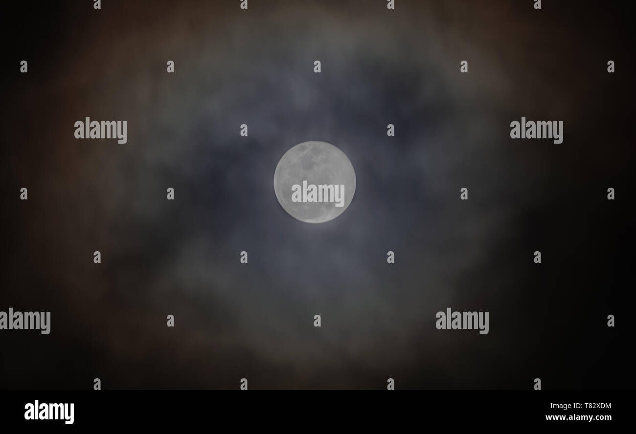 Full moon, with clouds passing over Stock Photo - Alamy