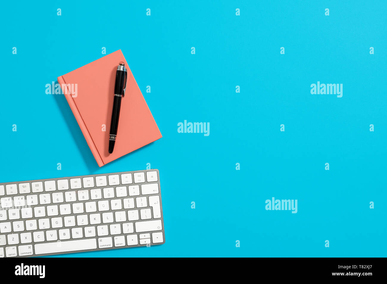 Orange hardcover notebook, diary, journal on a blue background with ...