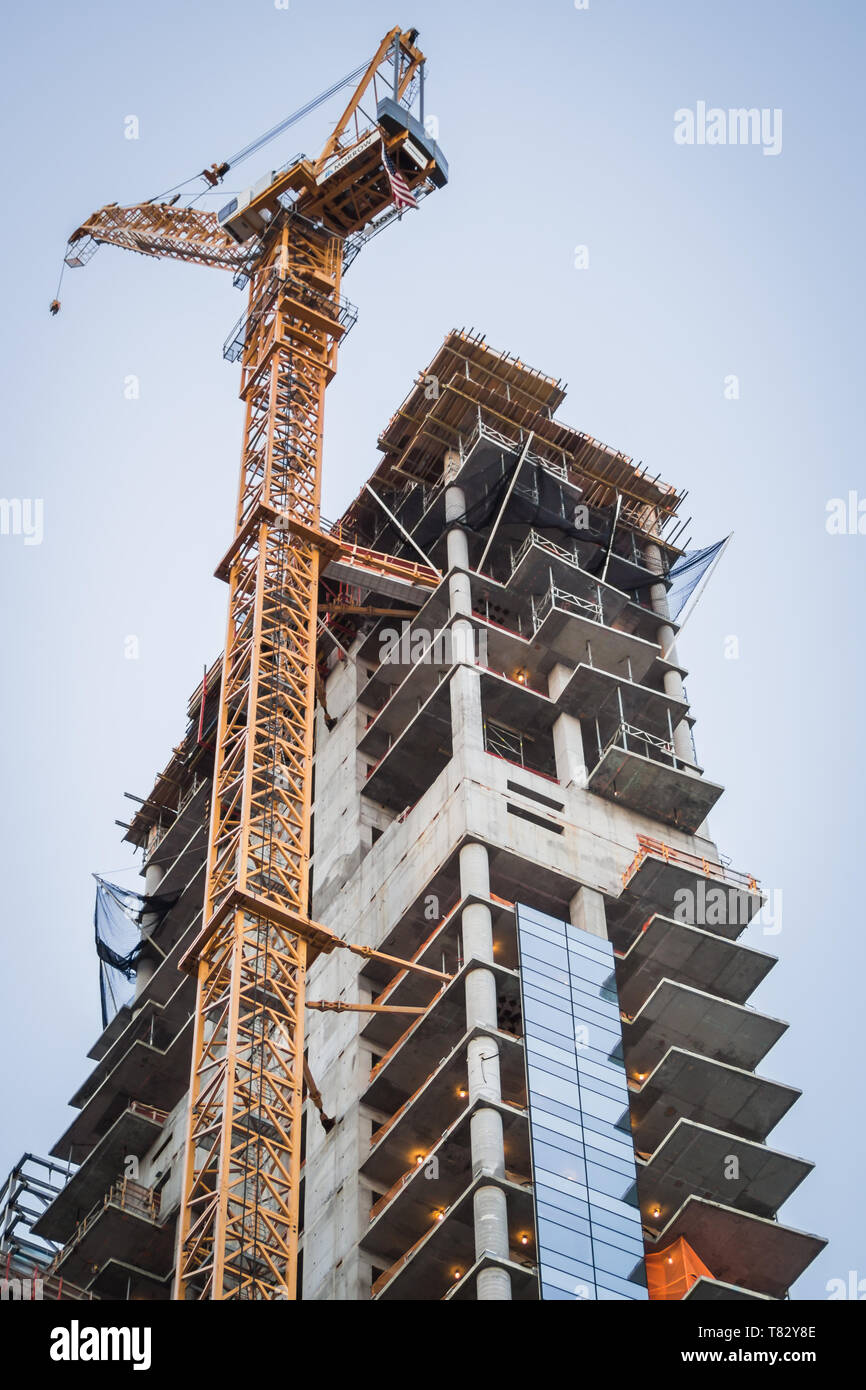 Skyscraper under construction with crane in the heart of Manhattan in ...