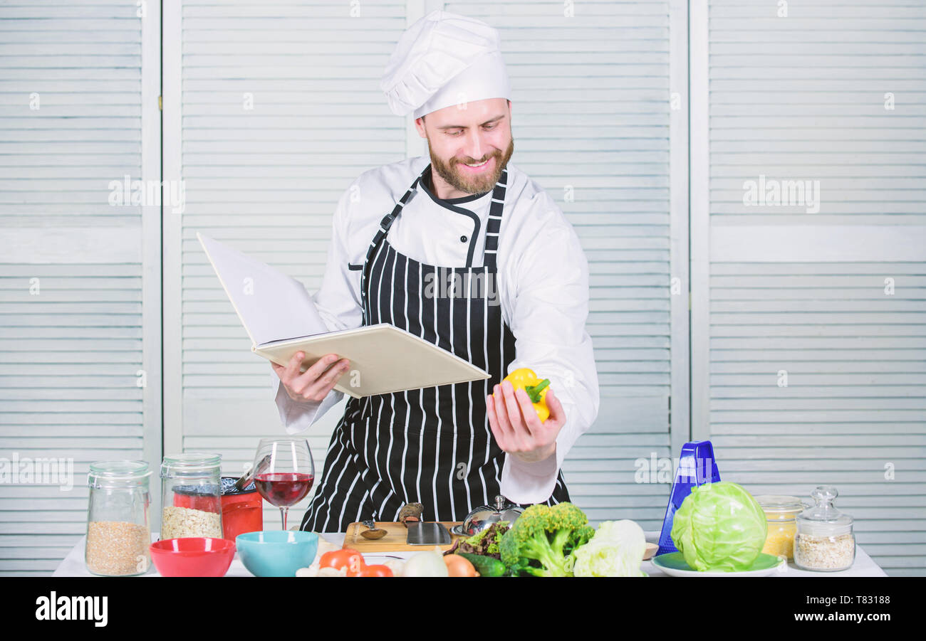 Book family recipes. According to recipe. Man bearded chef cooking food ...