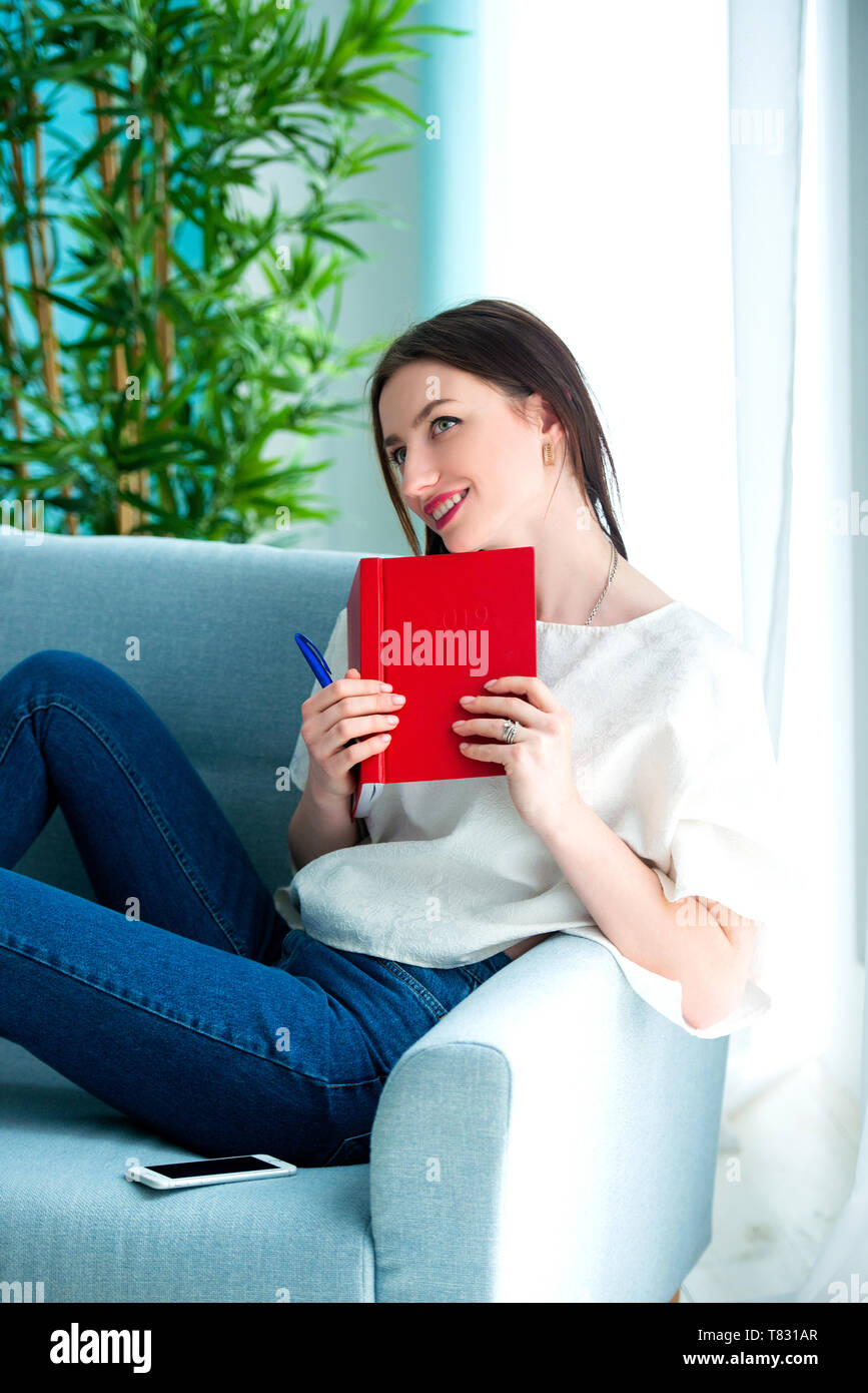 girl with a red note book at home Stock Photo - Alamy